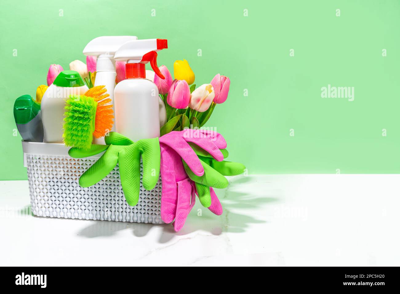 Set of cleaning supplies and utensils, with spring flowers on high ...