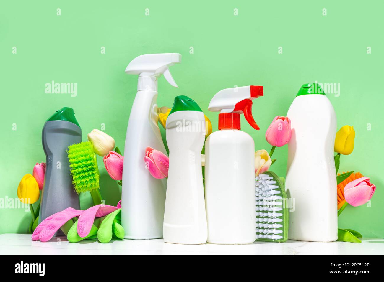 Set of cleaning supplies and utensils, with spring flowers on high ...