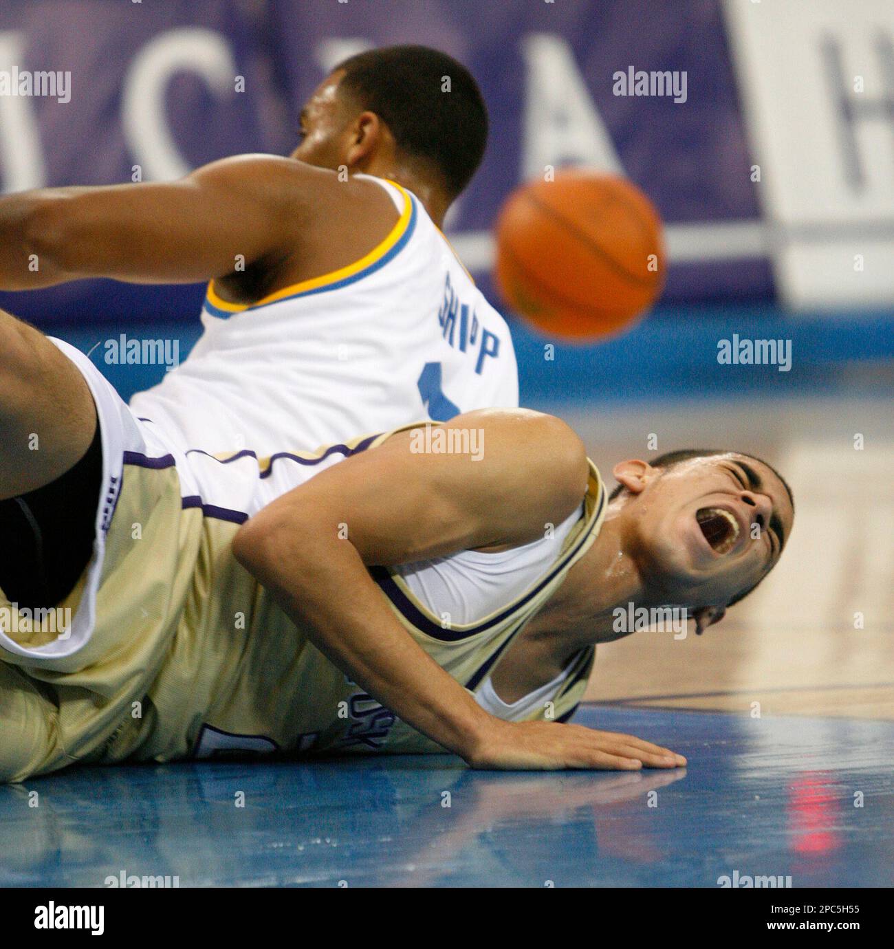 Washington guard Adrian Olivier, front, screams as UCLA guard Josh ...