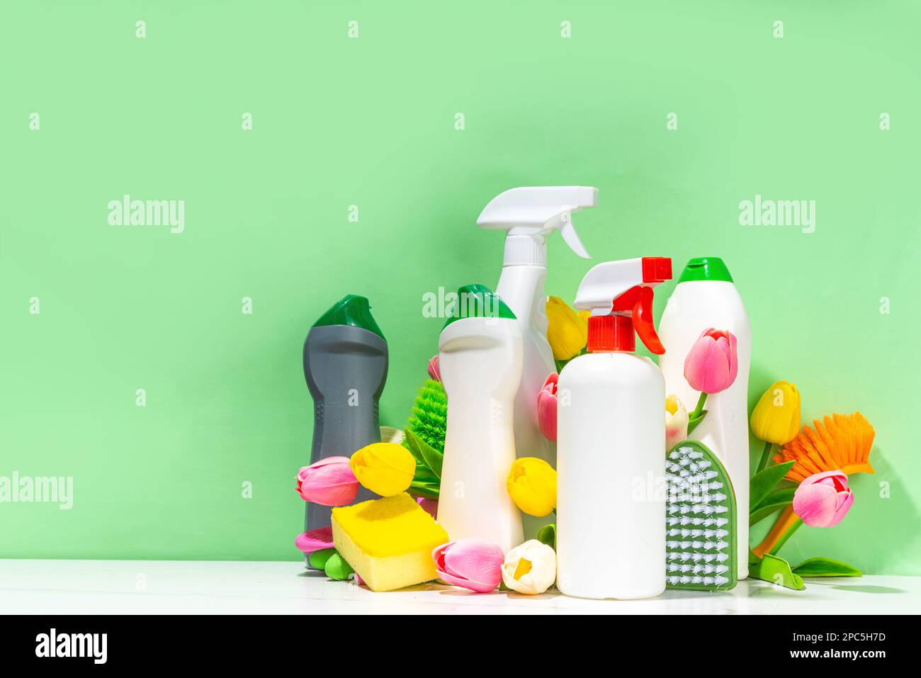 Set of cleaning supplies and utensils, with spring flowers on high ...