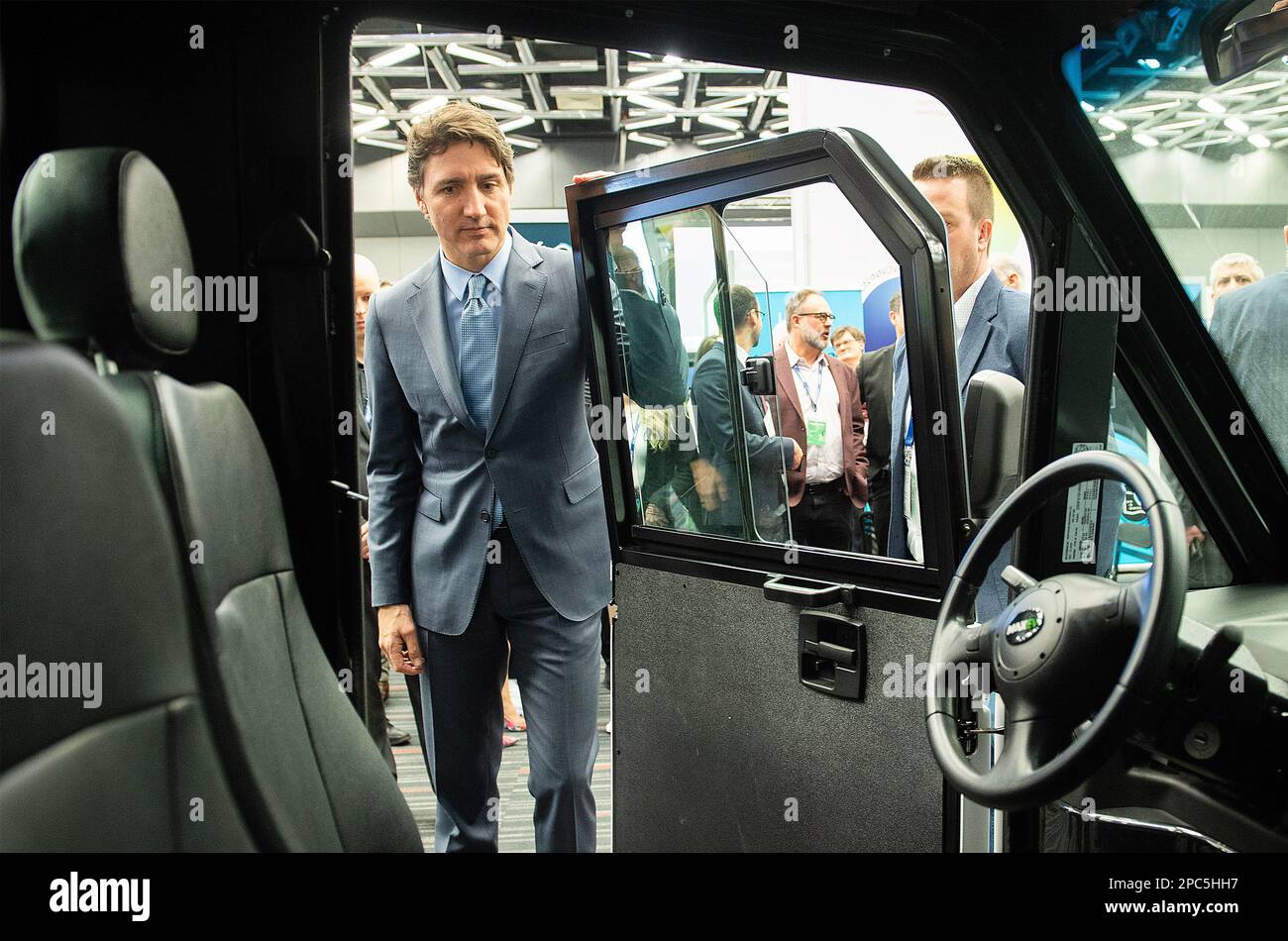 Prime Minister Justin Trudeau looks into the cabin of an electric ...