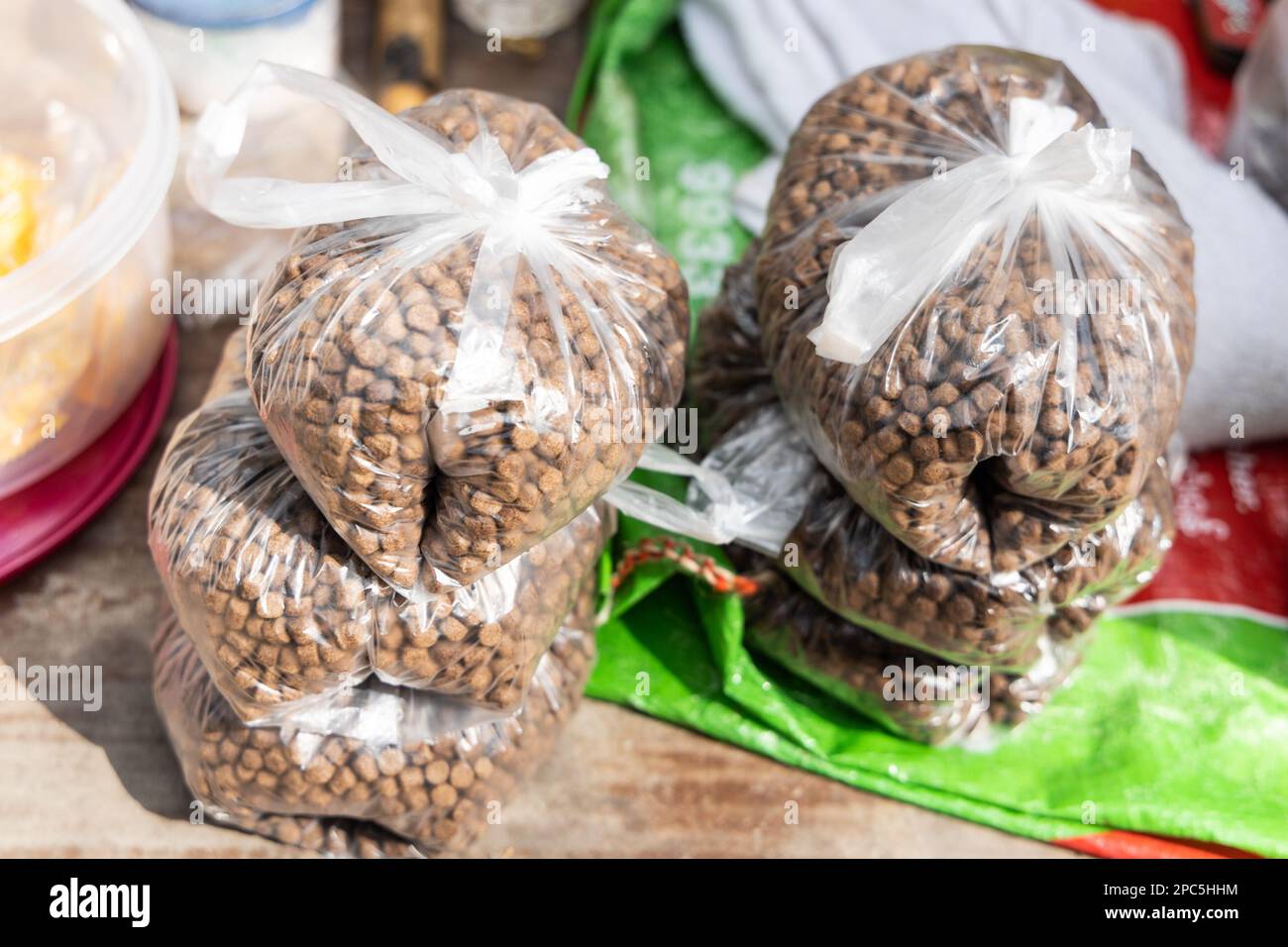 Fish food pallet are available for sale at the entrance of the Tham Nam ...