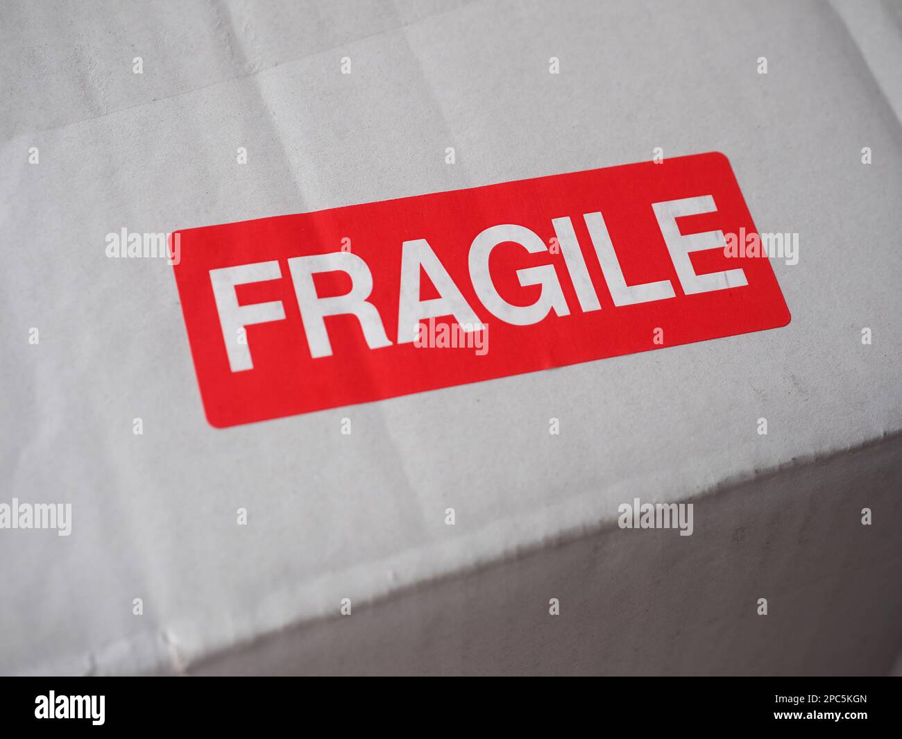 fragile warning sign label tag on a cardboard box Stock Photo - Alamy