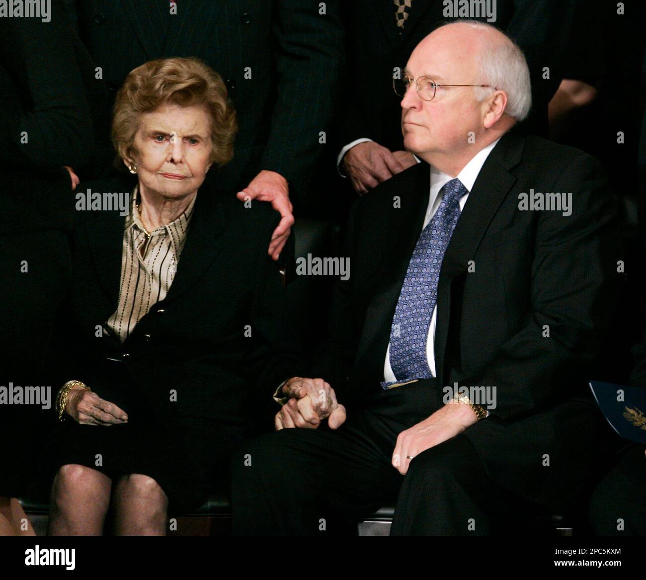 Vice President Dick Cheney, right, holds the hand of former first lady ...