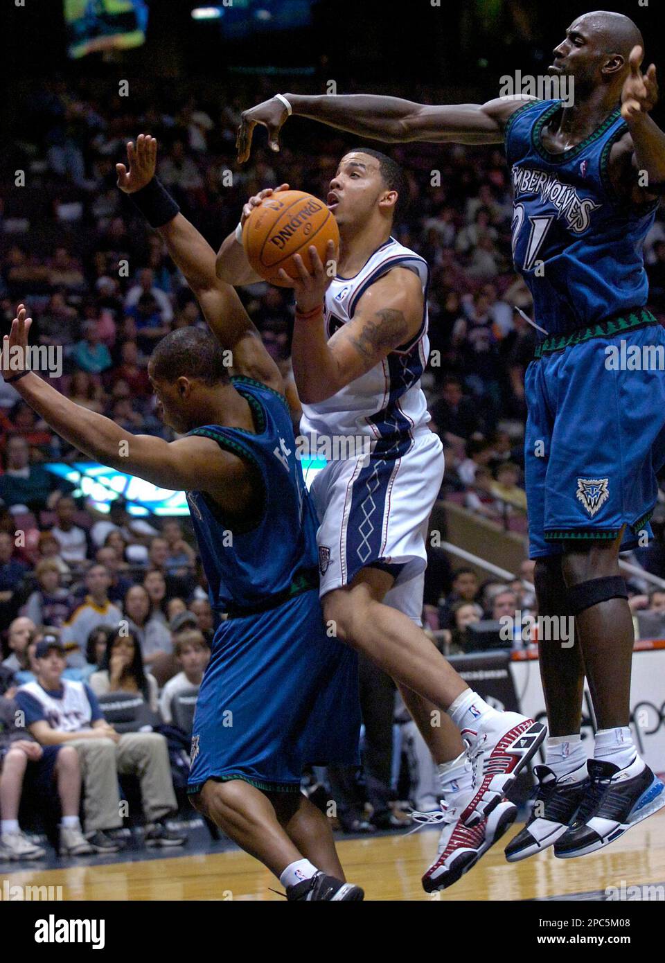 New Jersey Nets' Marcus Williams goes up with a shot as he splits the ...
