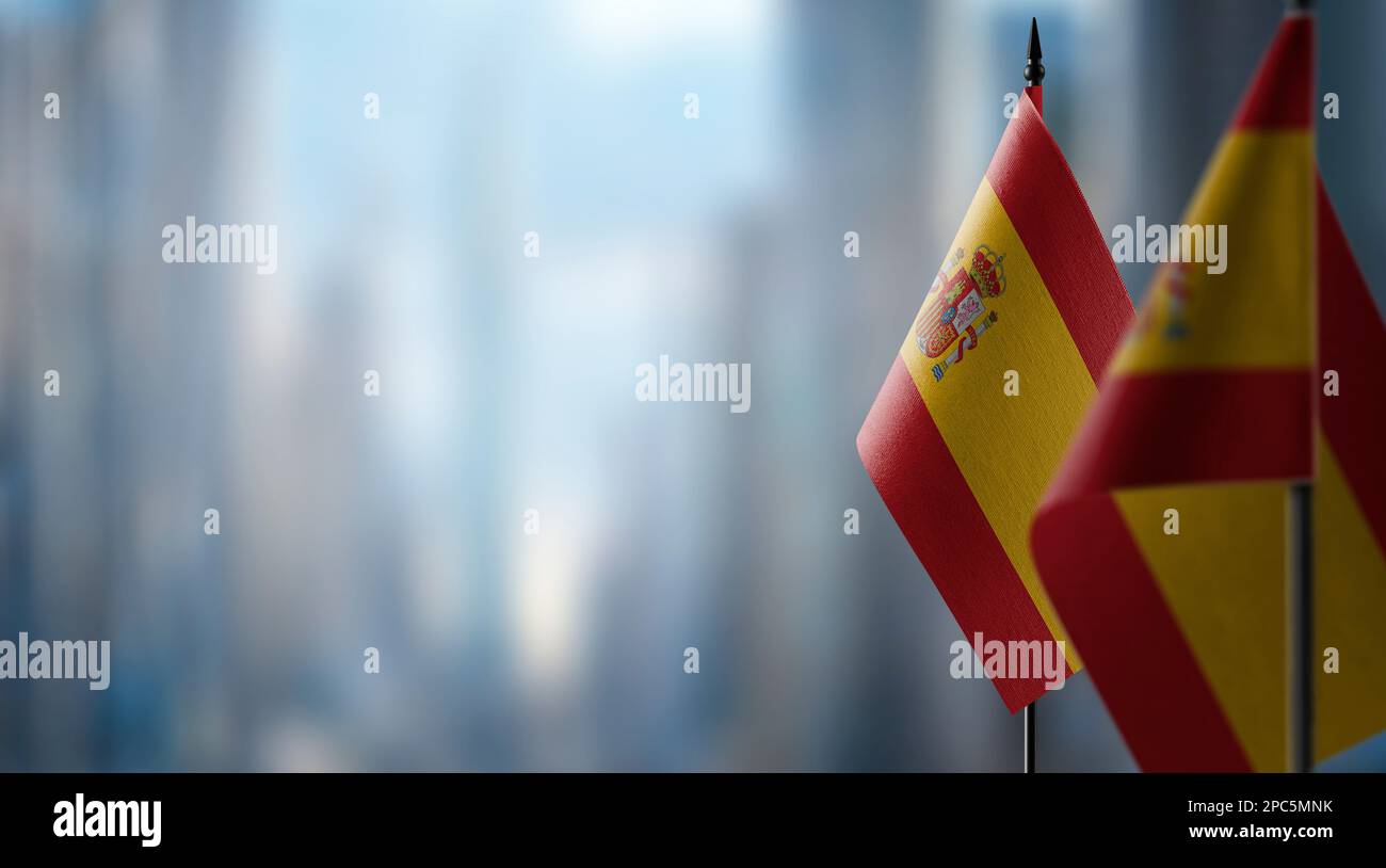 Small flags of the Spain on an abstract blurry background Stock Photo ...