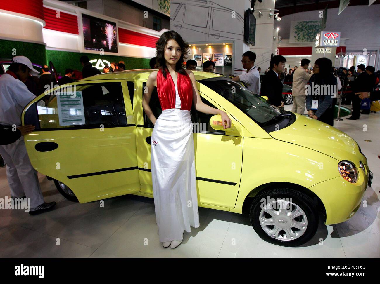 A model poses beside a Chery QQ car at the Beijing Auto Show in this ...