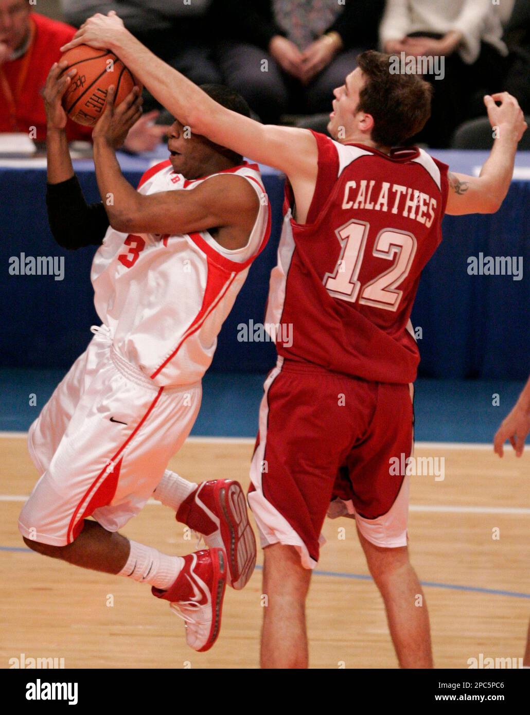 St. Joseph's Pat Calathes, right, gets his hand on the ball for a block ...