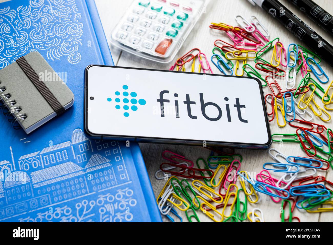 In this photo illustration a Fitbit logo seen displayed on a smartphone ...