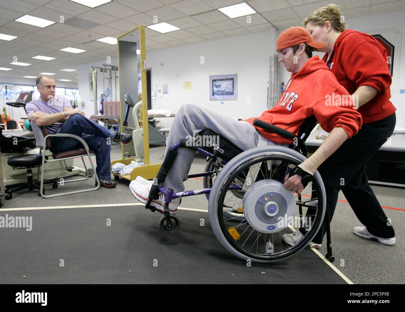 Tyson Gentry uses his arm to pull up on a ramp as he operates a manual ...