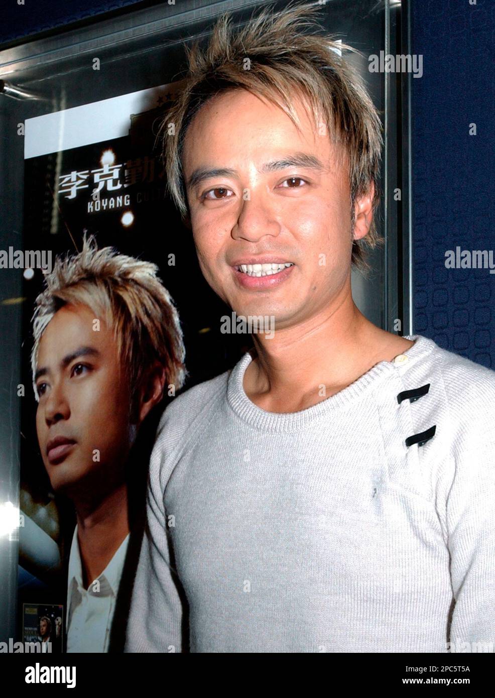 Hong Kong singer Hacken Lee poses for photographers during a ...