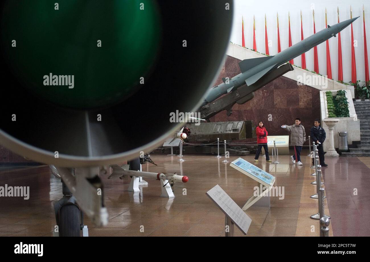 Chinese visitors look at antiquated Chinese military hardware on ...