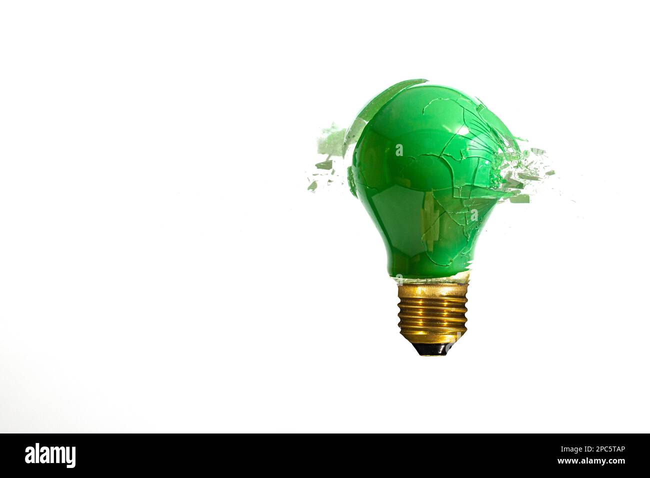 green bulb breaking on white background Stock Photo - Alamy