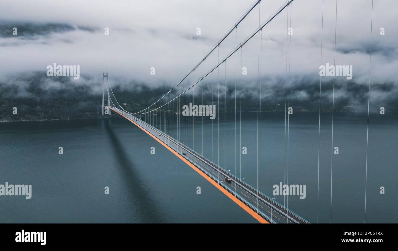 the hardanger bridge stretches across a vast expanse of ocean with ...