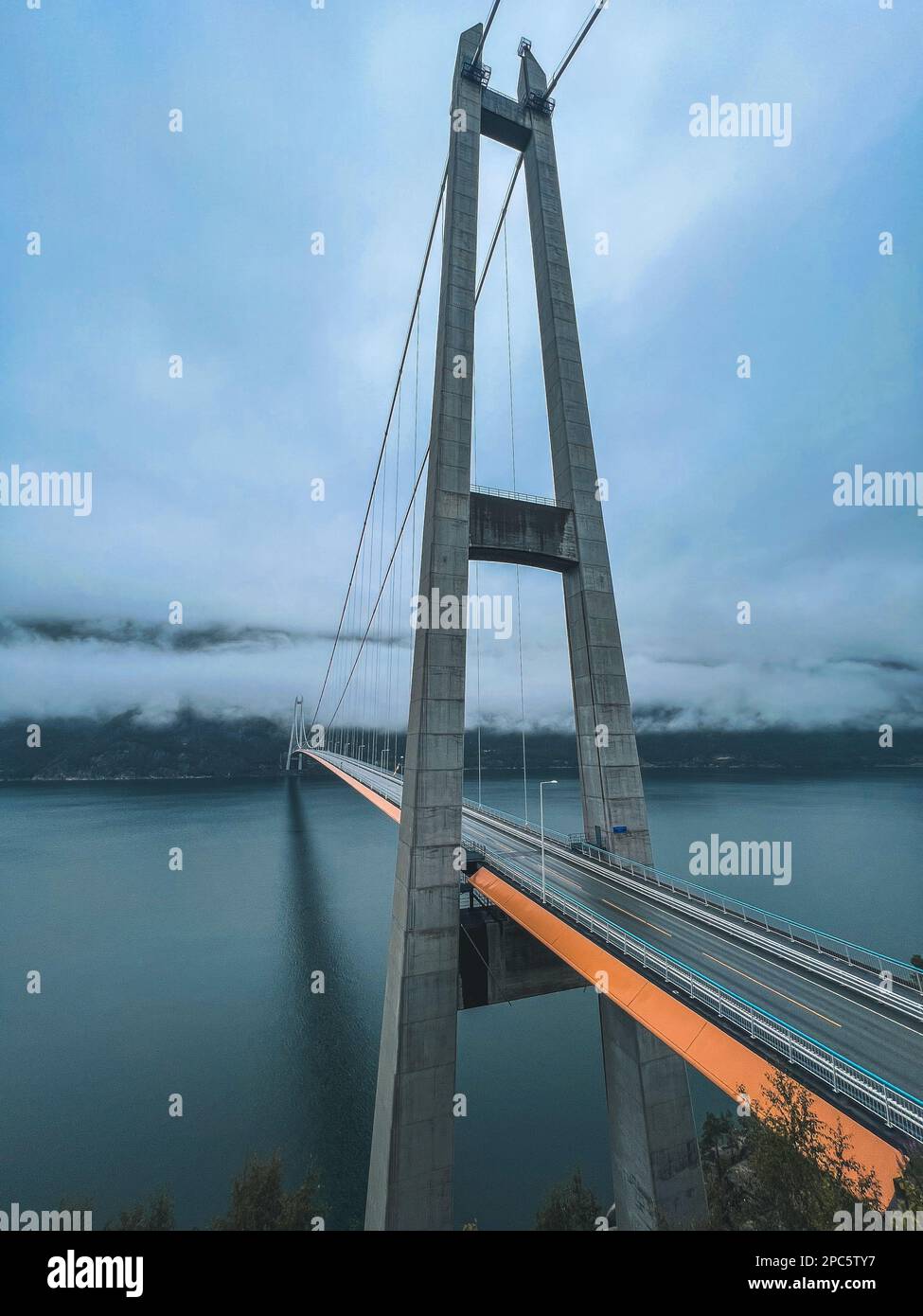 a close up of Hardanger bridge stretches across a vast expanse of ocean ...