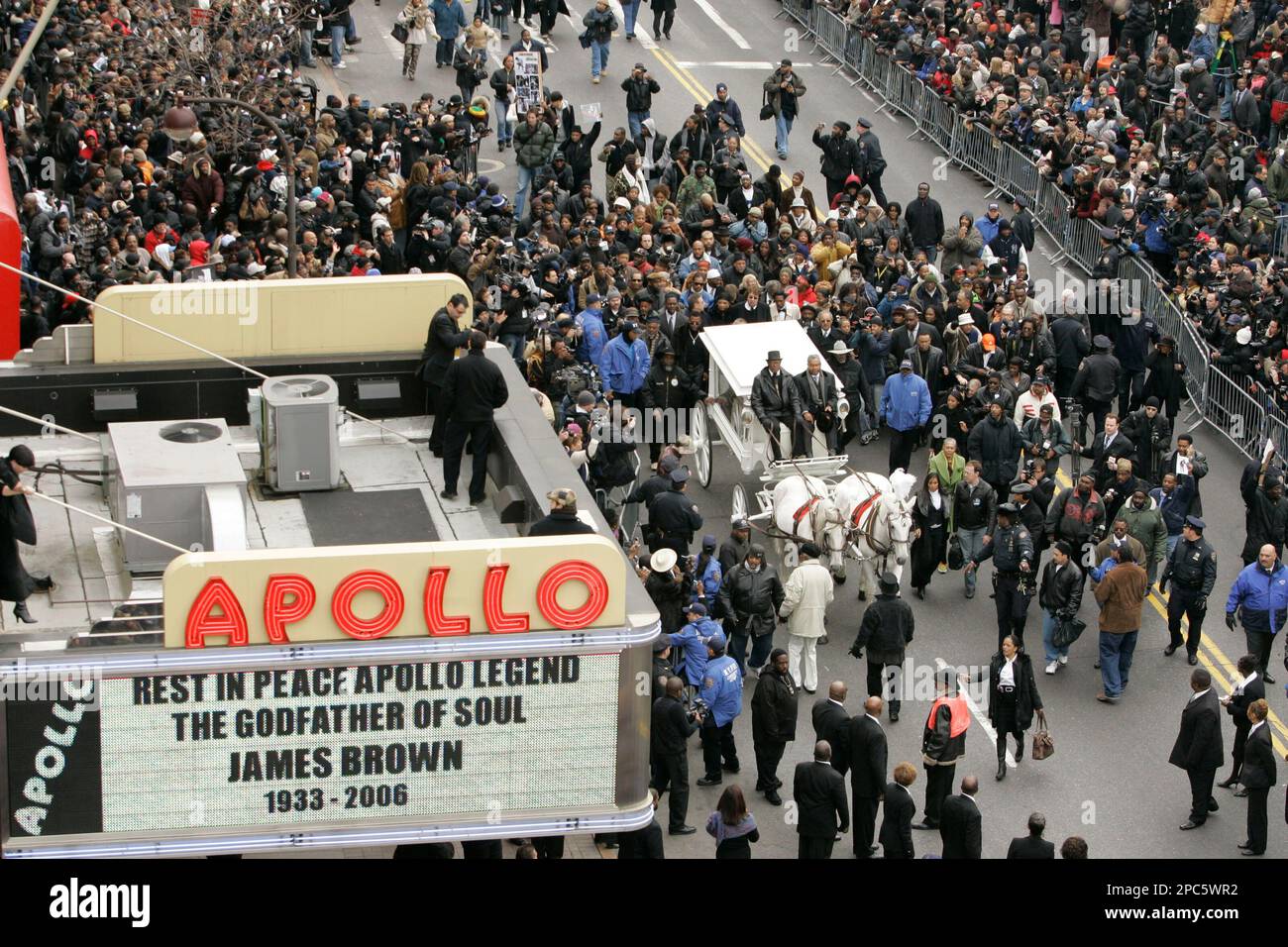 The horse drawn carriage with James Brown's casket arrives at the ...