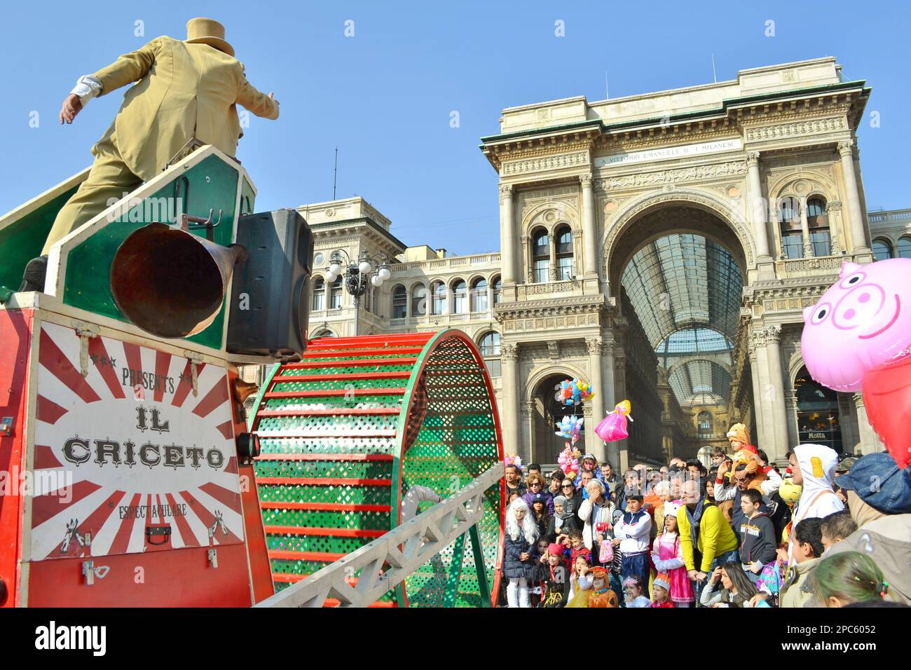 Festive crowd dressed as carnival watch a circus show "Il Criceto ...