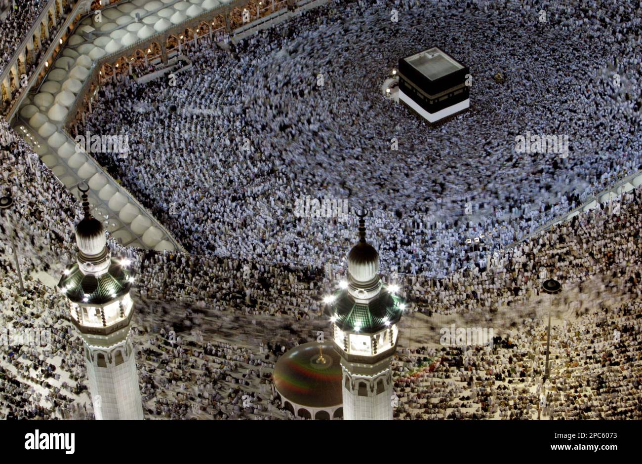 Tens of thousands of Muslim pilgrims move around the Kaaba, the black ...