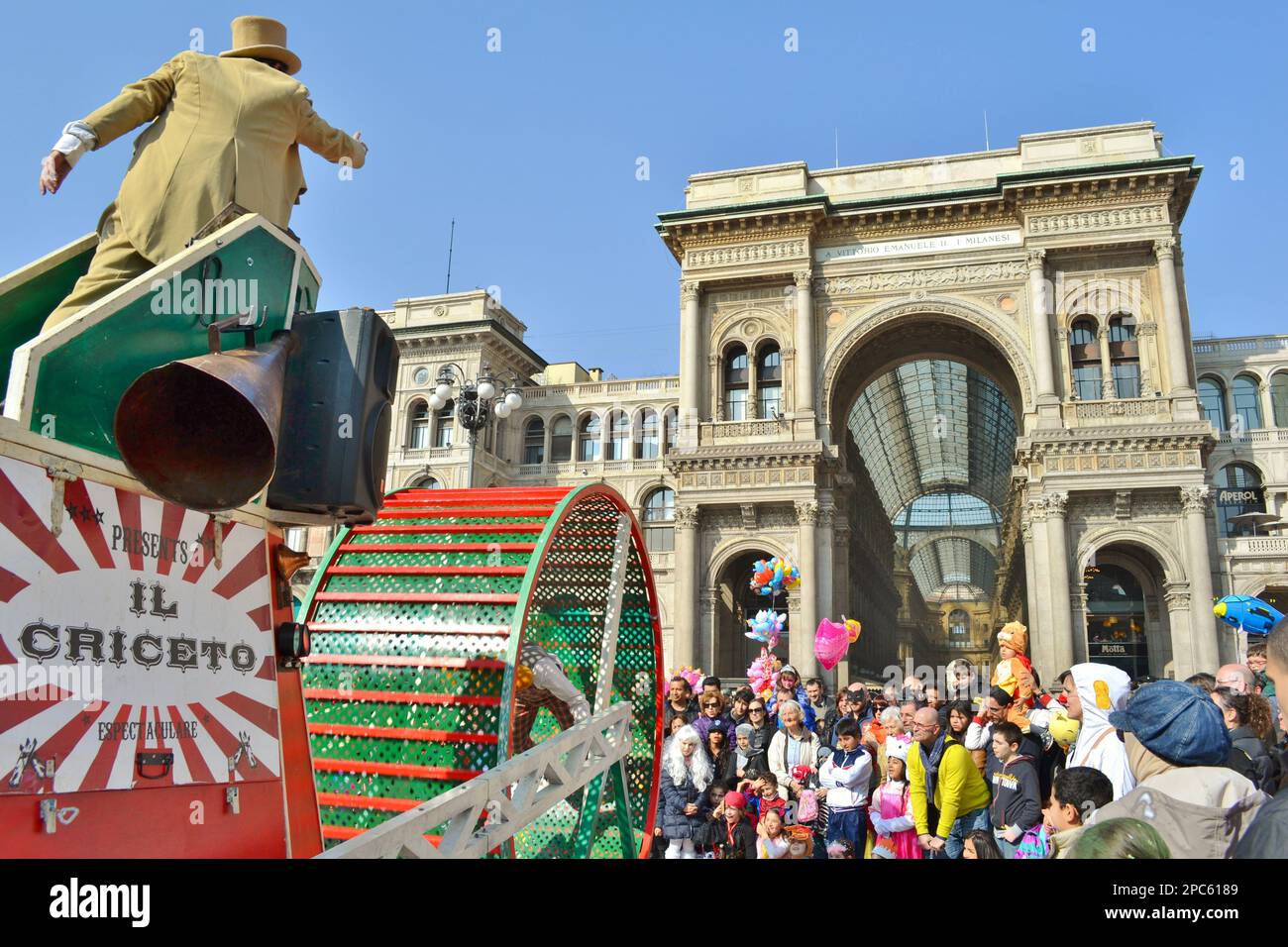 Festive crowd dressed as carnival watch a circus show "Il Criceto ...