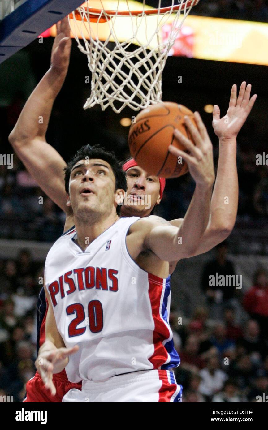 Detroit Pistons guard Carlos Delfino (20), of Argentina, is defended by ...