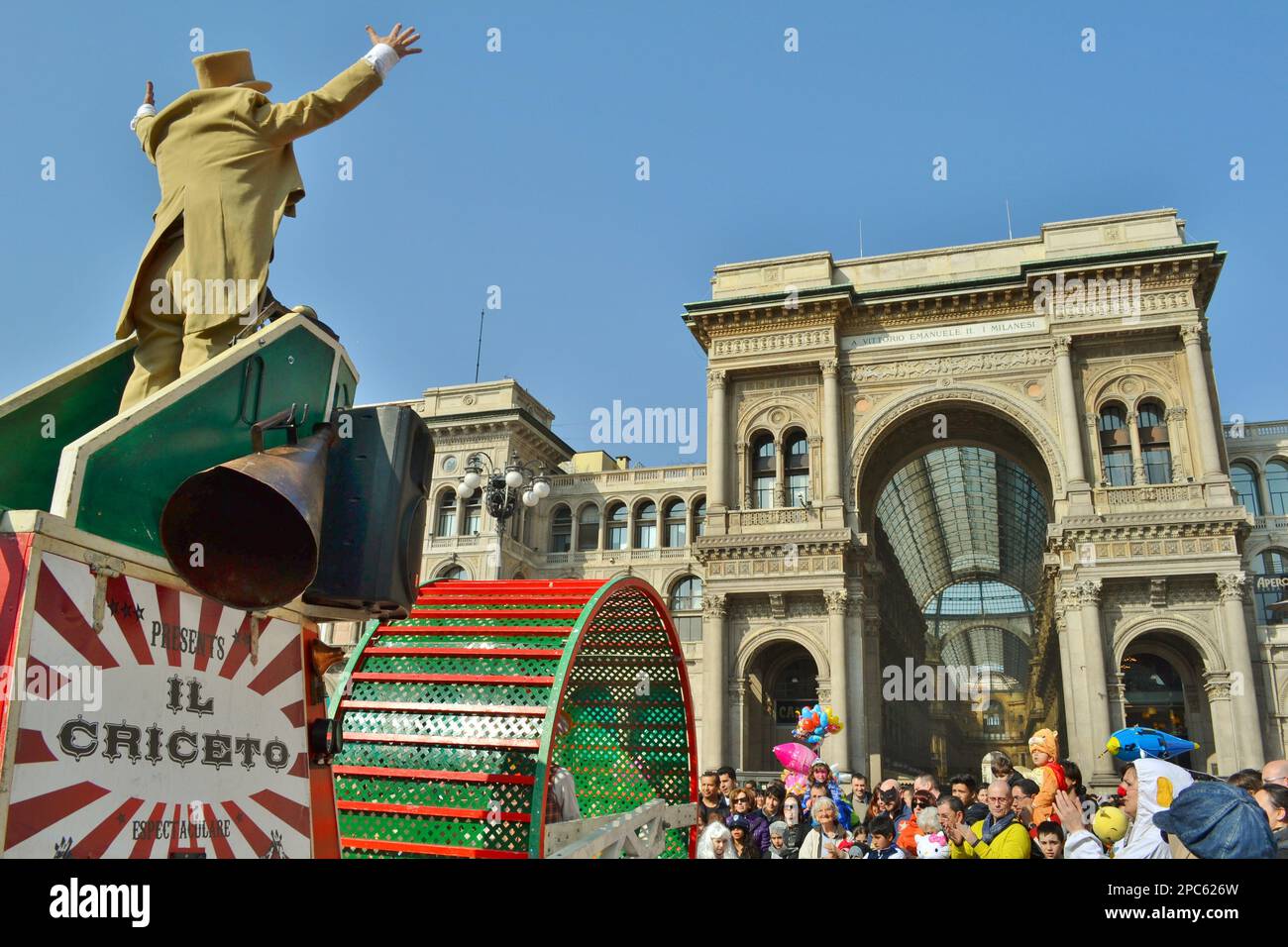 Festive crowd dressed as carnival watch a circus show "Il Criceto ...