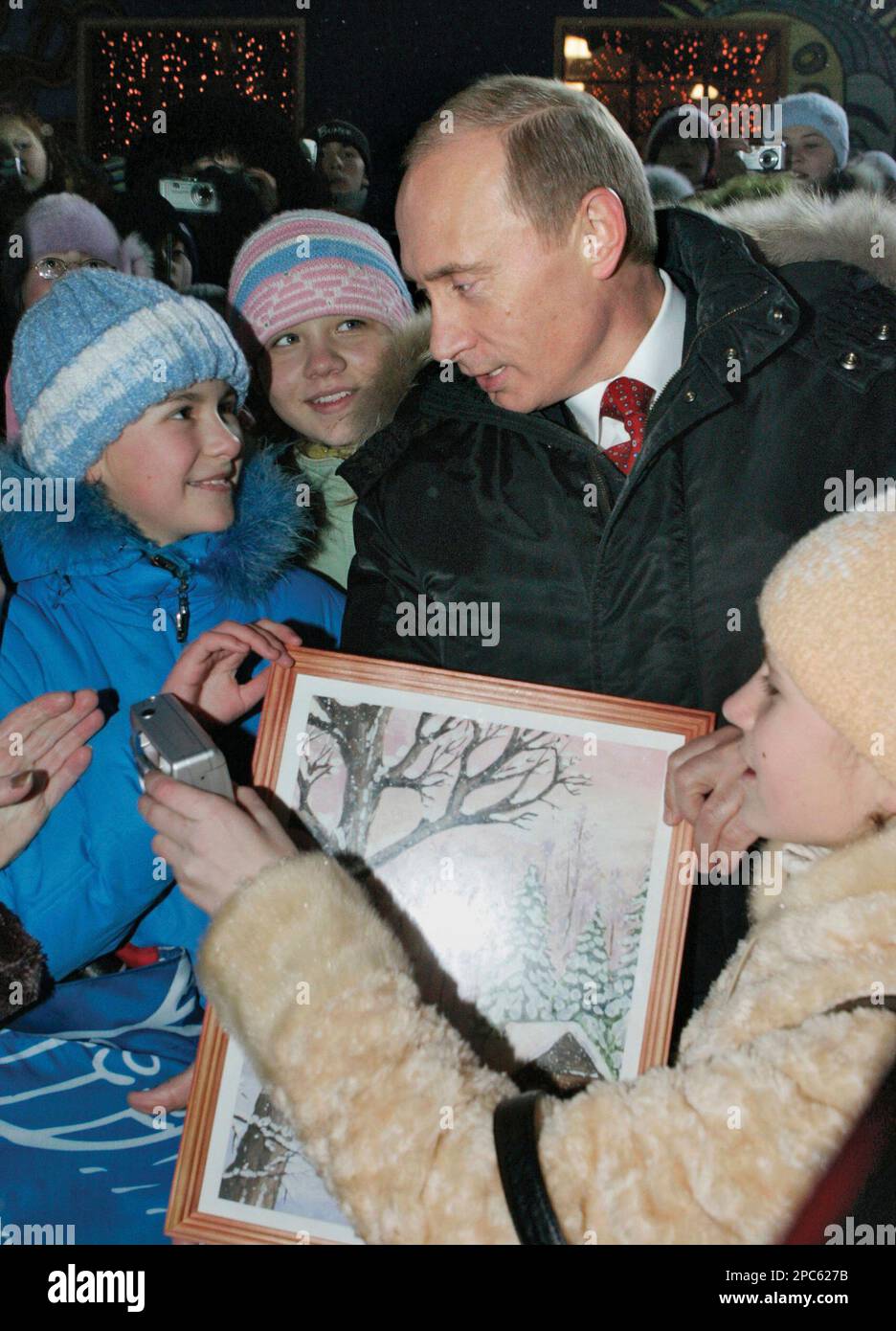 Russian President Vladimir Putin seen with children on a skating rink ...