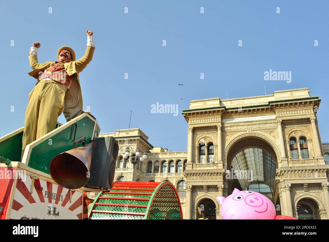 Festive crowd dressed as carnival watch a circus show "Il Criceto ...