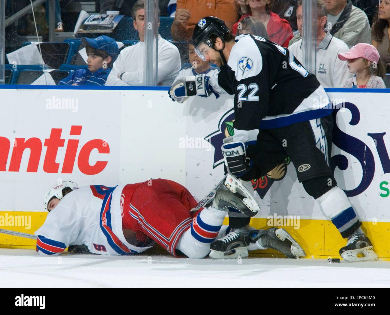 Tampa Bay Lightning's Dan Boyle, right, tries to pull out his stick ...