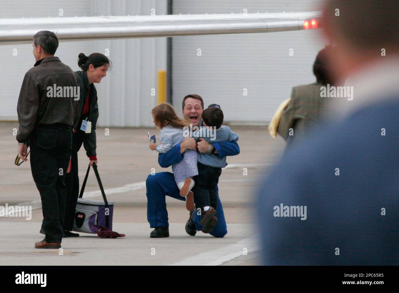 Discovery astronaut Nicholas Patrick greets his children Cecilia, 3 ...