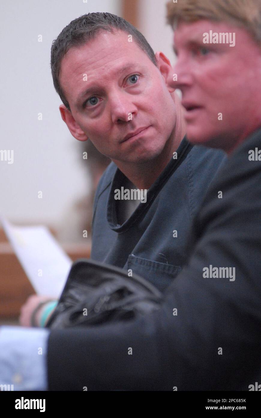 Chaz Higgs sits with his lawyer David Houston before his arraignment ...