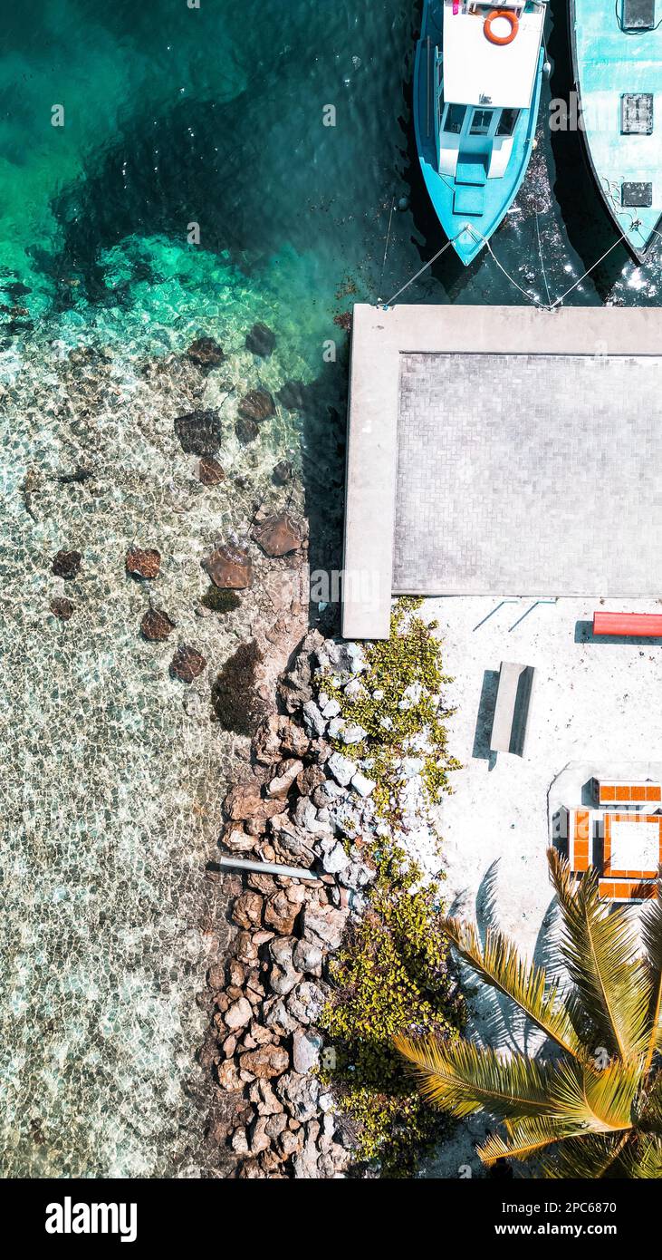 An aerial view of a small harbor with boats resting peacefully on the ...