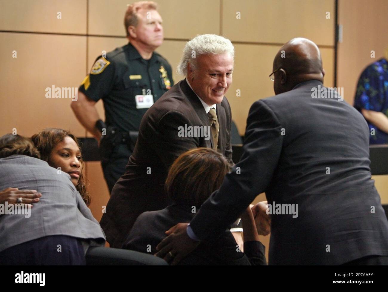 David Slutsker, center, attorney for Richard Williams, shakes hands ...