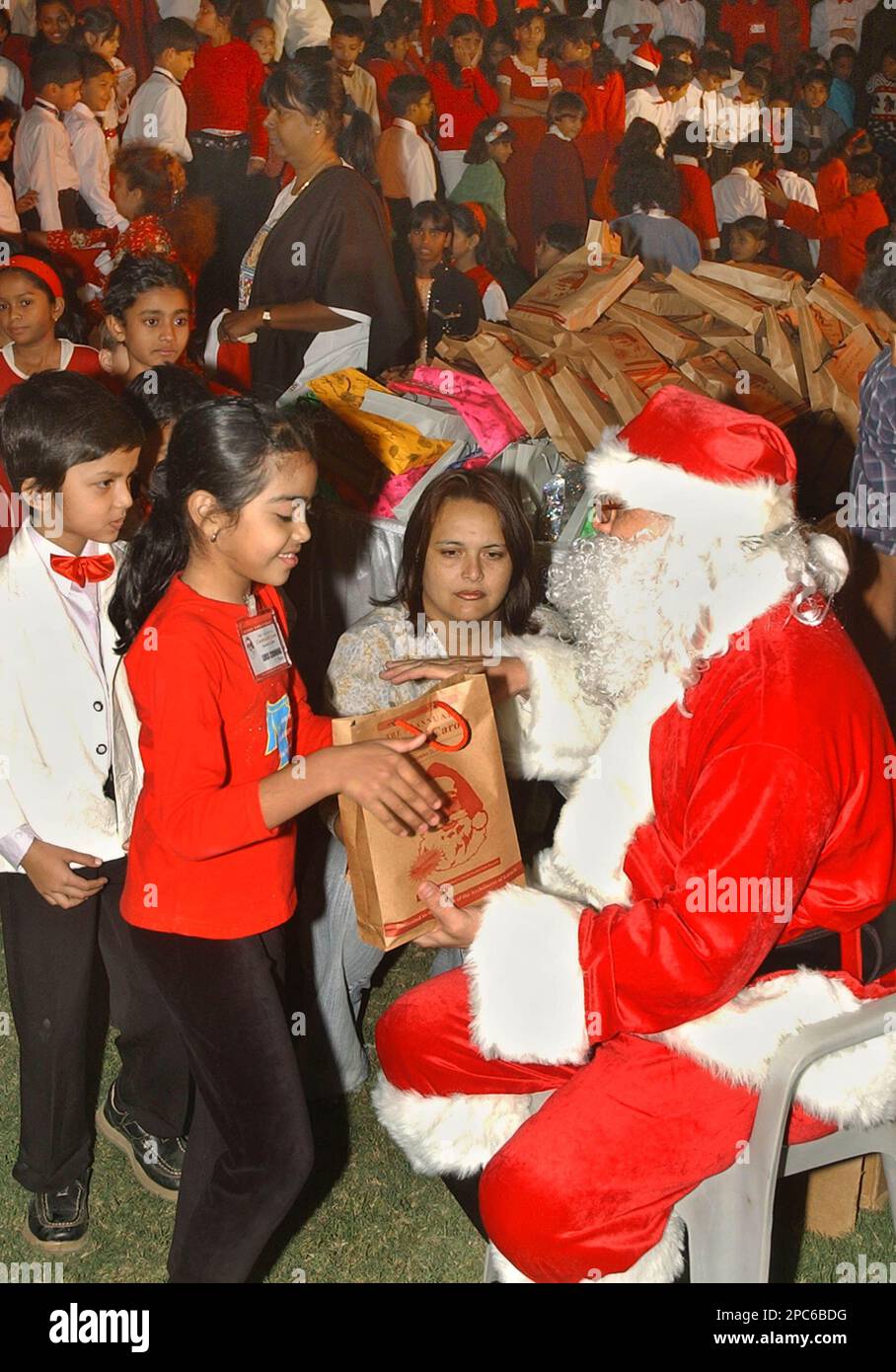 A Pakistani person dressed as Santa Claus distributes gift's among the ...