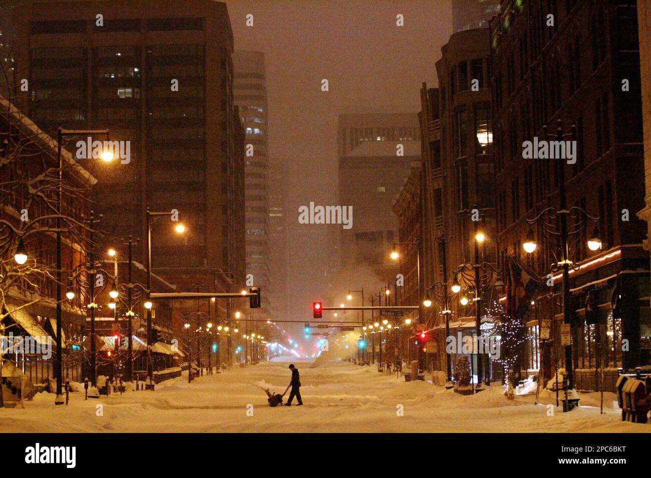 Oxford Hotel maintenance man Ben Bath clears snow off a section of the ...