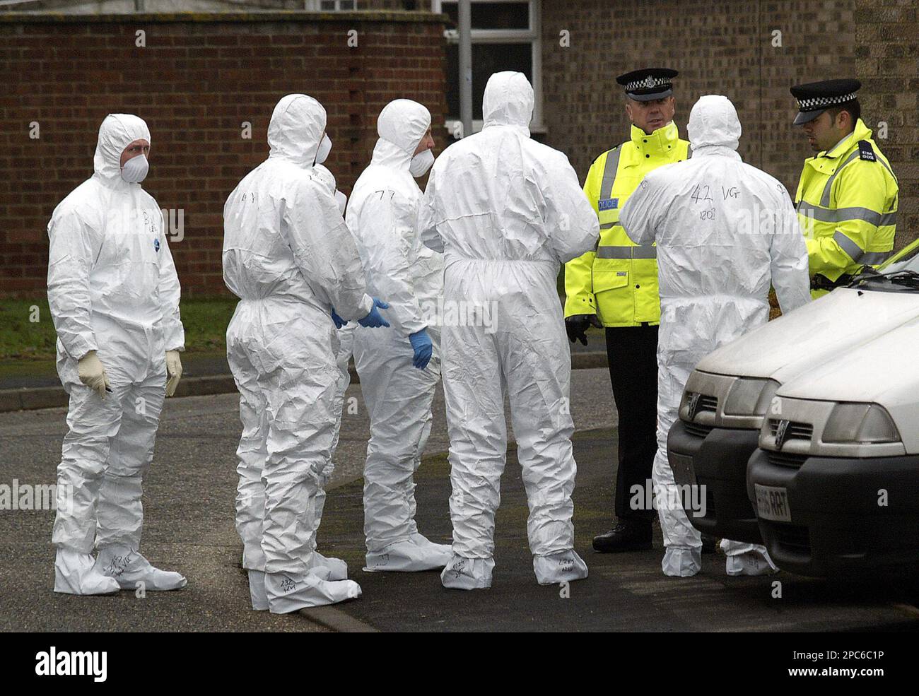 British forensic experts talk to police officers, before resuming their ...