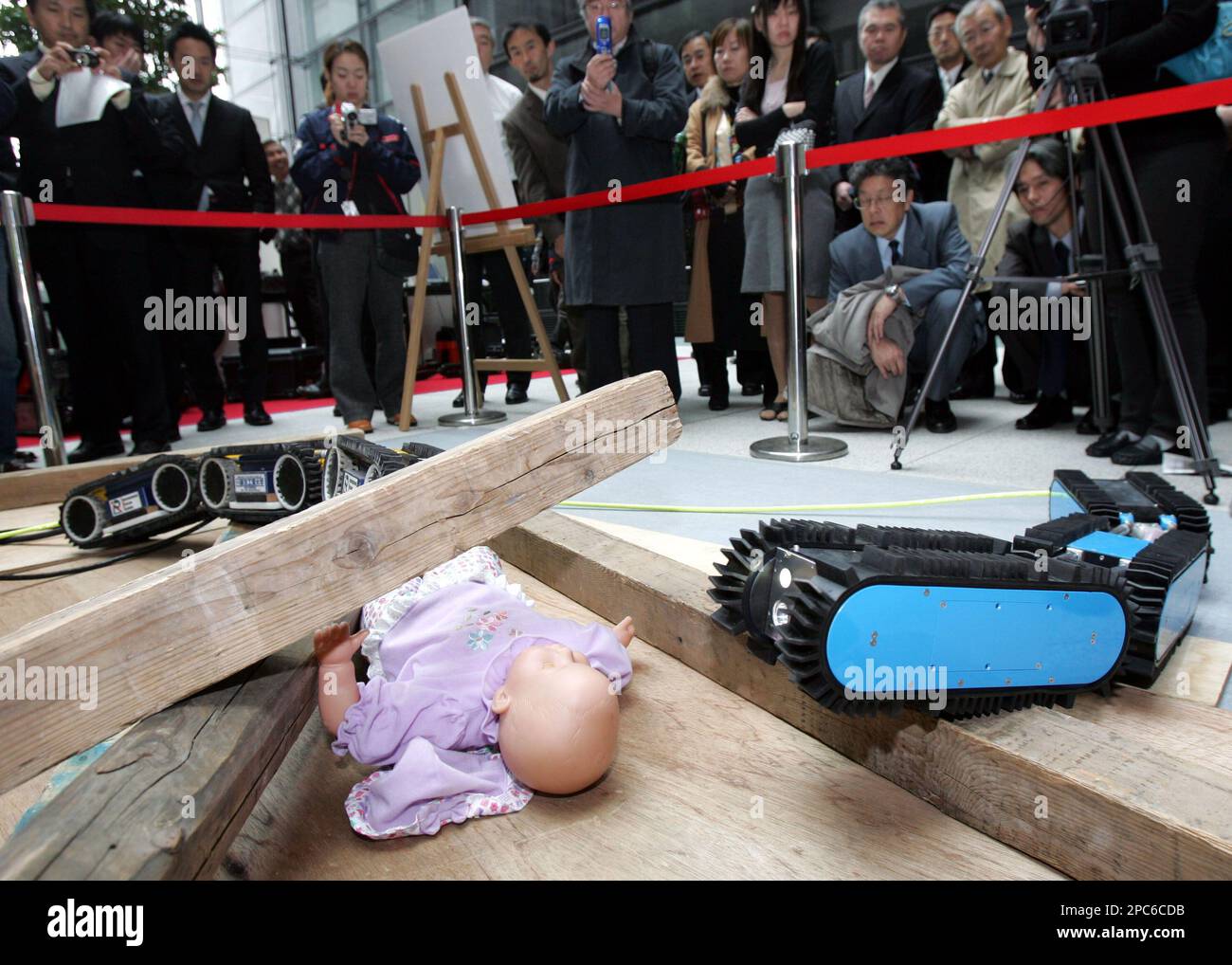 An advanced type of the rescue robot Hyper-Soryu 4, right, goes over ...