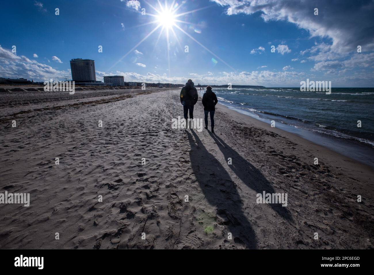 Rostock, Germany. 13th Mar, 2023. Walkers are on the beach in ...