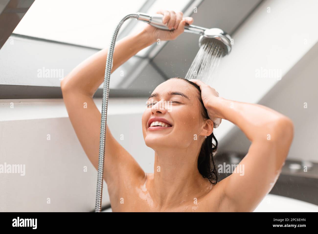 Cheerful Female Taking Shower Washing Hair And Body In Bathroom Stock
