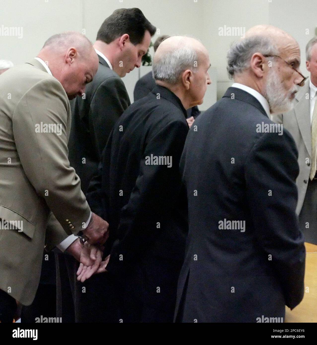 ** FILE ** Court officer Bob Dietrich handcuffs The Rev. Gerald ...