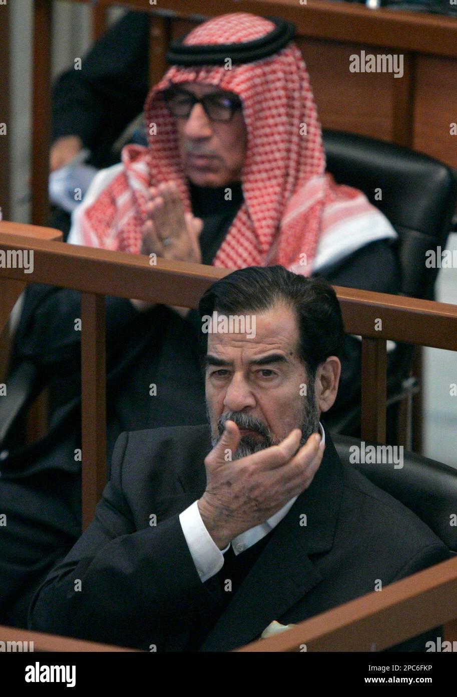 Ousted Iraqi President Saddam Hussein sits in court, in front of co ...