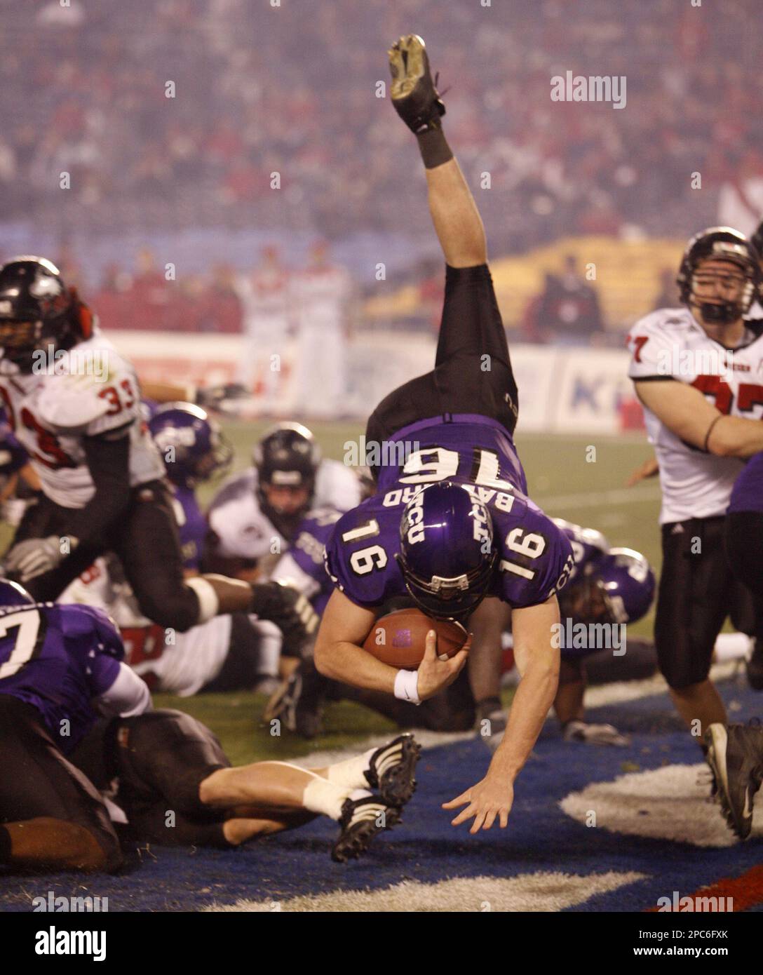 TCU quarterback Jeff Ballard dives into the end zone to score a ...