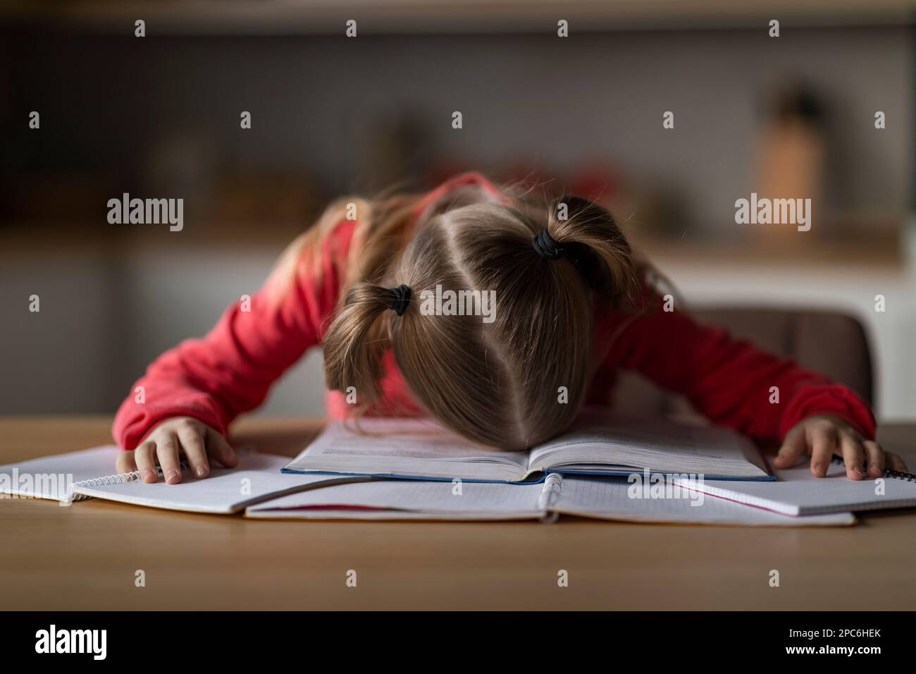 Portrait Of Tired Little Girl Sleeping At Desk While Doing School ...