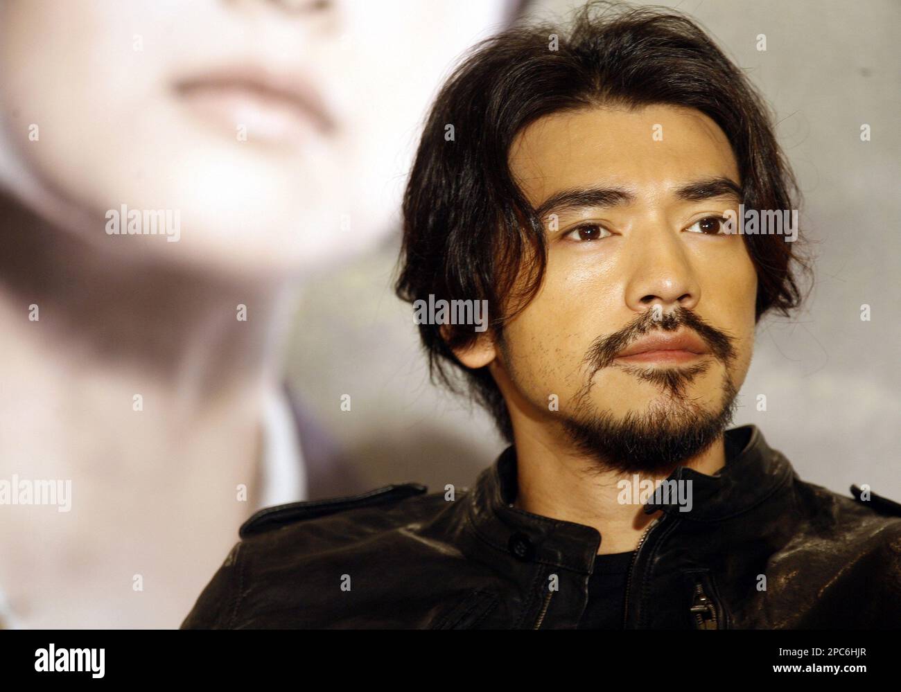 Taiwanese-Japanese actor Takeshi Kaneshiro listens to reporters ...