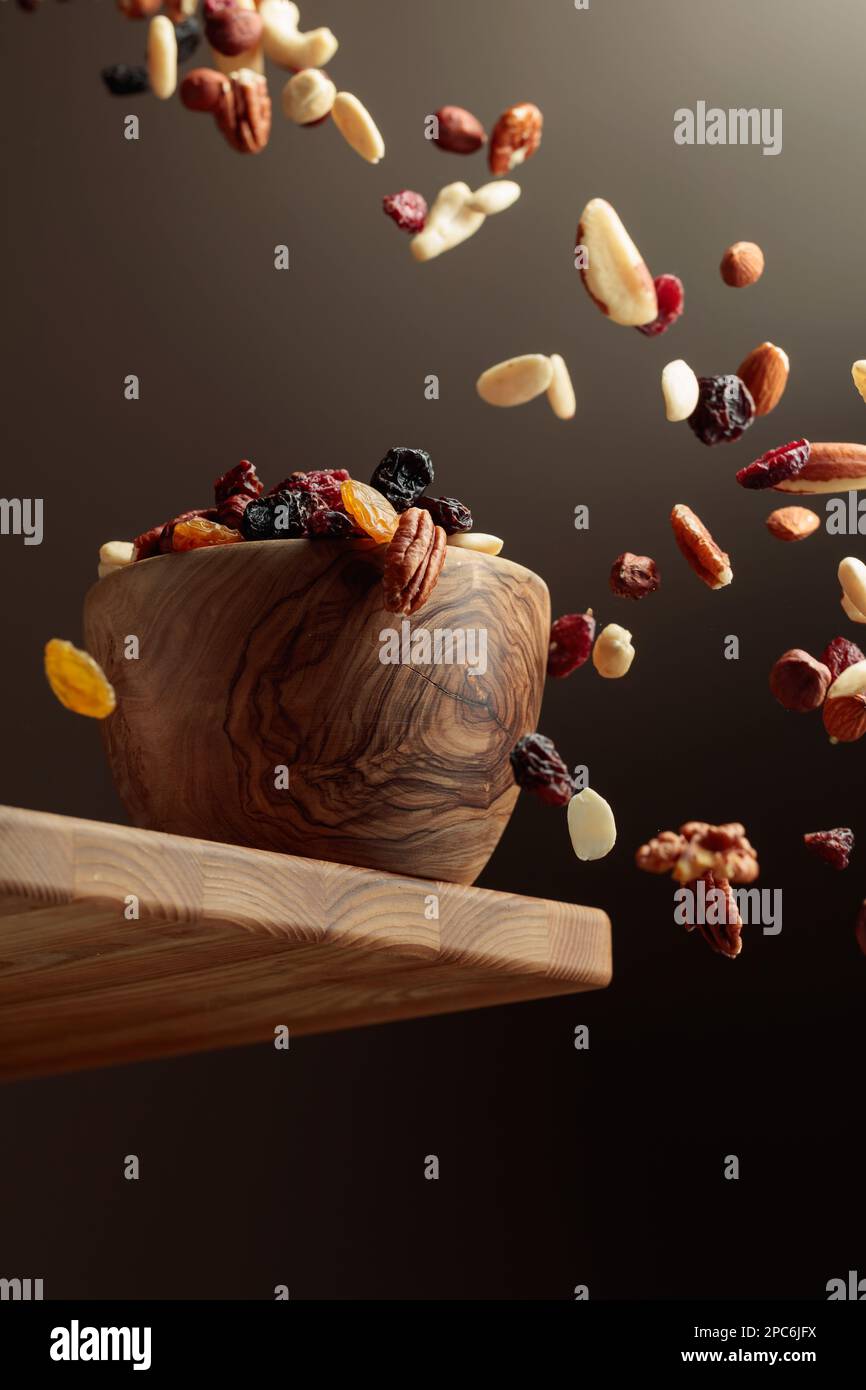 Flying dried fruits and nuts. The mix of nuts and dried berries are in ...