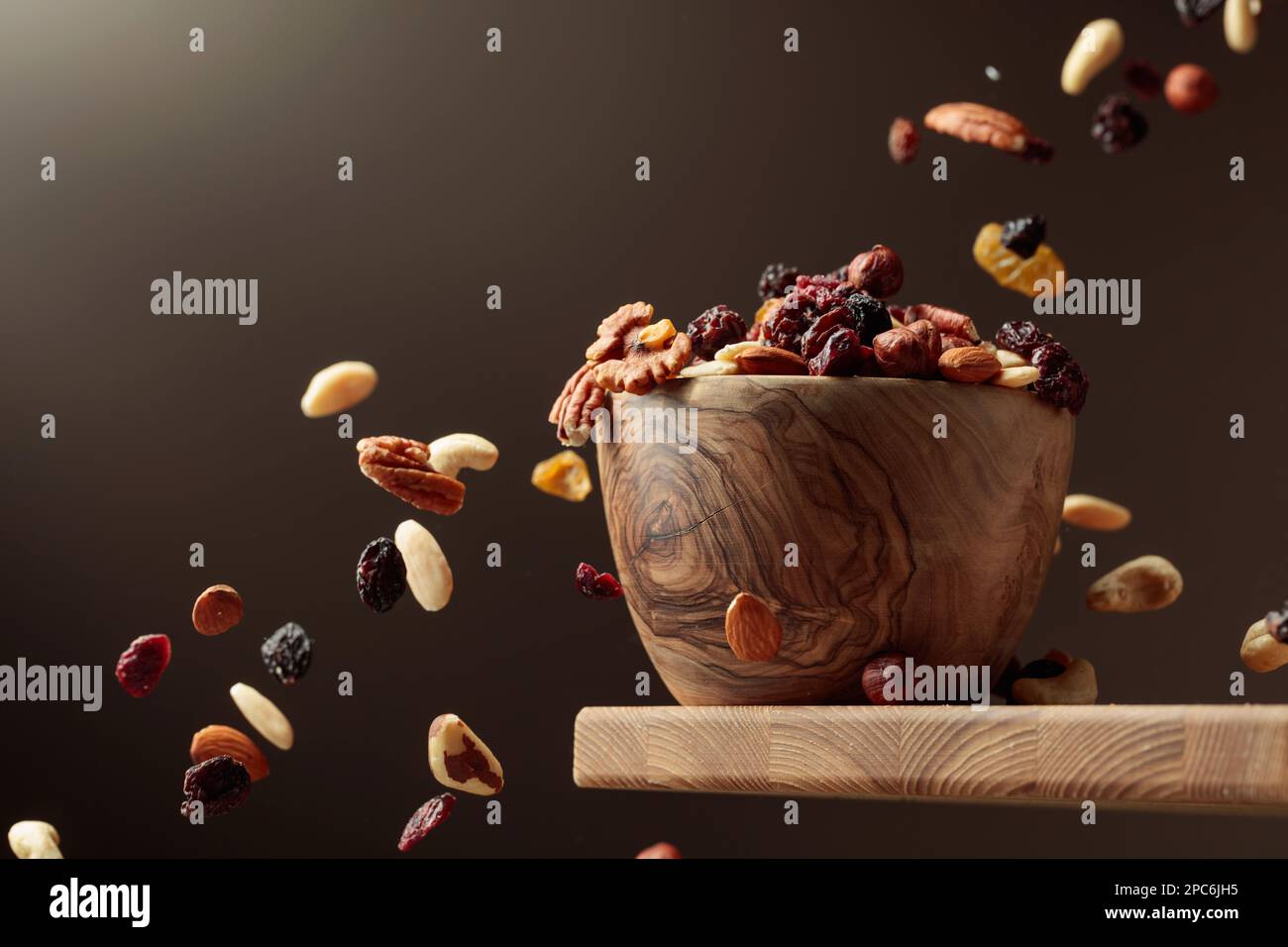 Flying dried fruits and nuts. The mix of nuts and dried berries are in ...