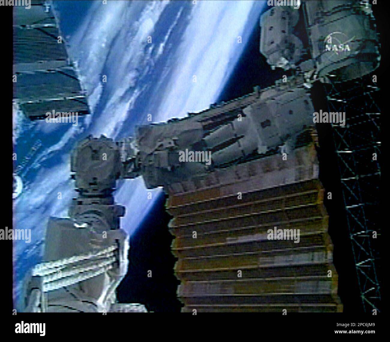 In this image from NASA Television, space shuttle mission specialists ...