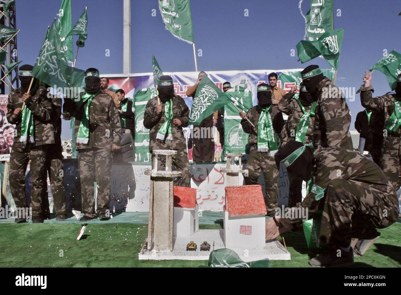 Palestinian masked Hamas university students blow up a model of an ...