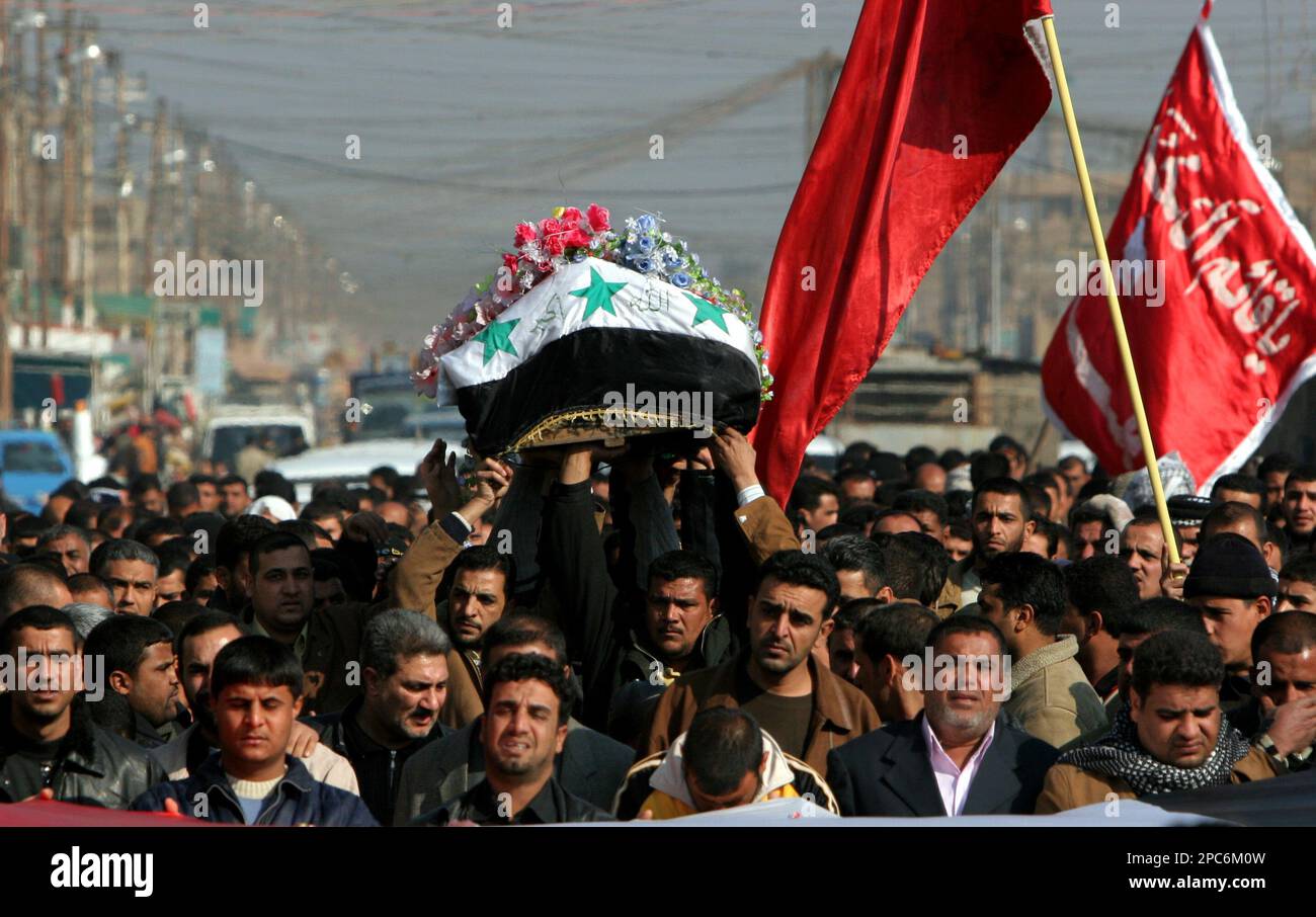 Iraqis carry a coffin with the body of Munqith Ahmed (29) through the ...