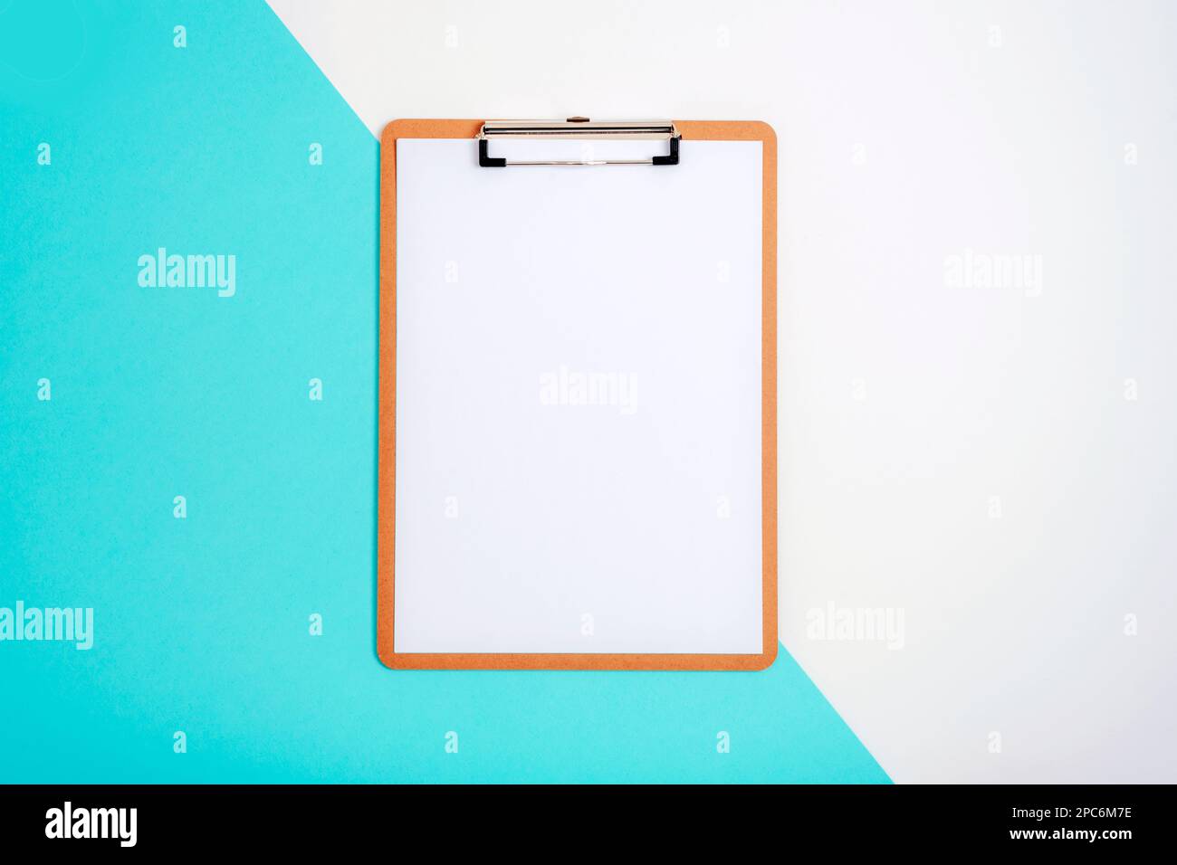 Clipboard with blank paper on blue and white background. Top view, flat ...