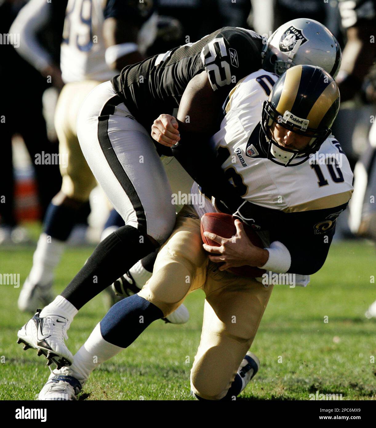 Oakland Raiders linebacker Kirk Morrison ,left, sacks St. Louis Rams ...